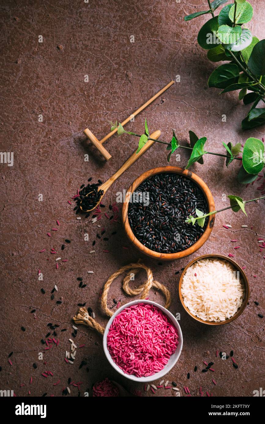 From above bowls with different types of rice placed on table near ...