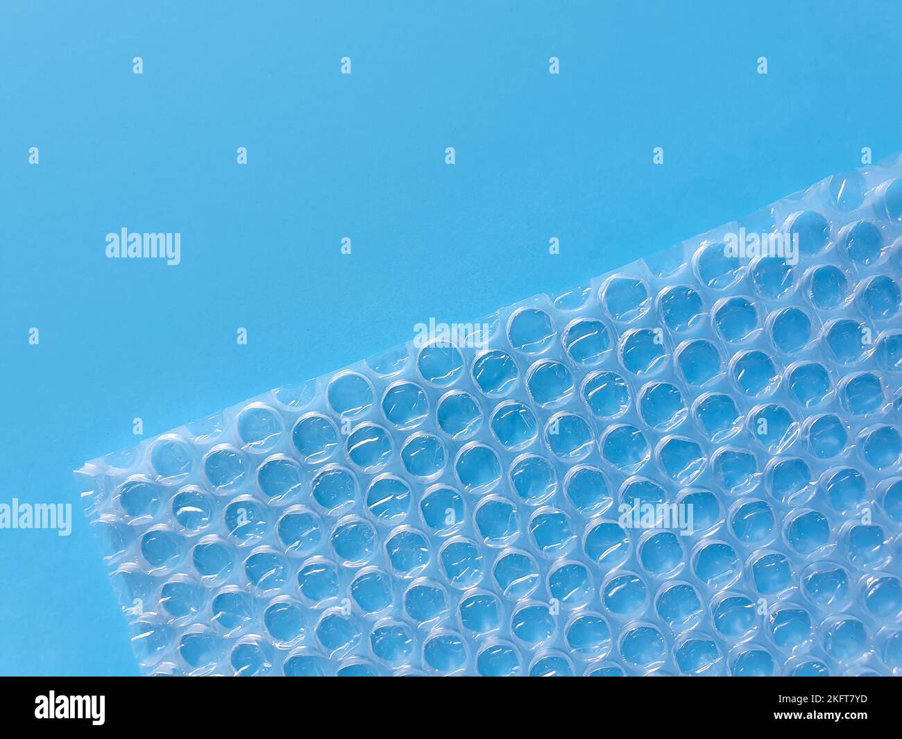 Bubble wrap packing or air cushion film on blue background. Closeup ...