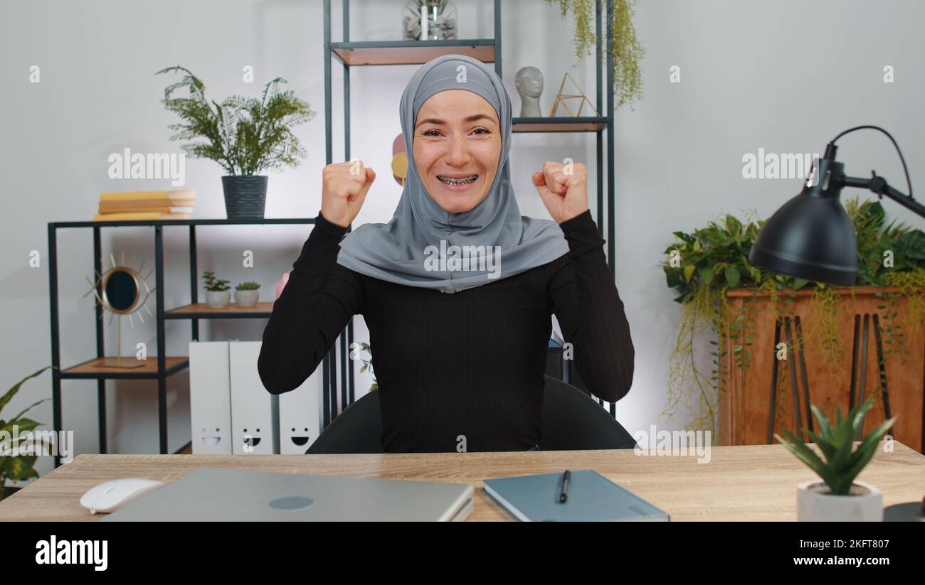 Happy young muslim business woman wearing hijab headscarf shouting ...