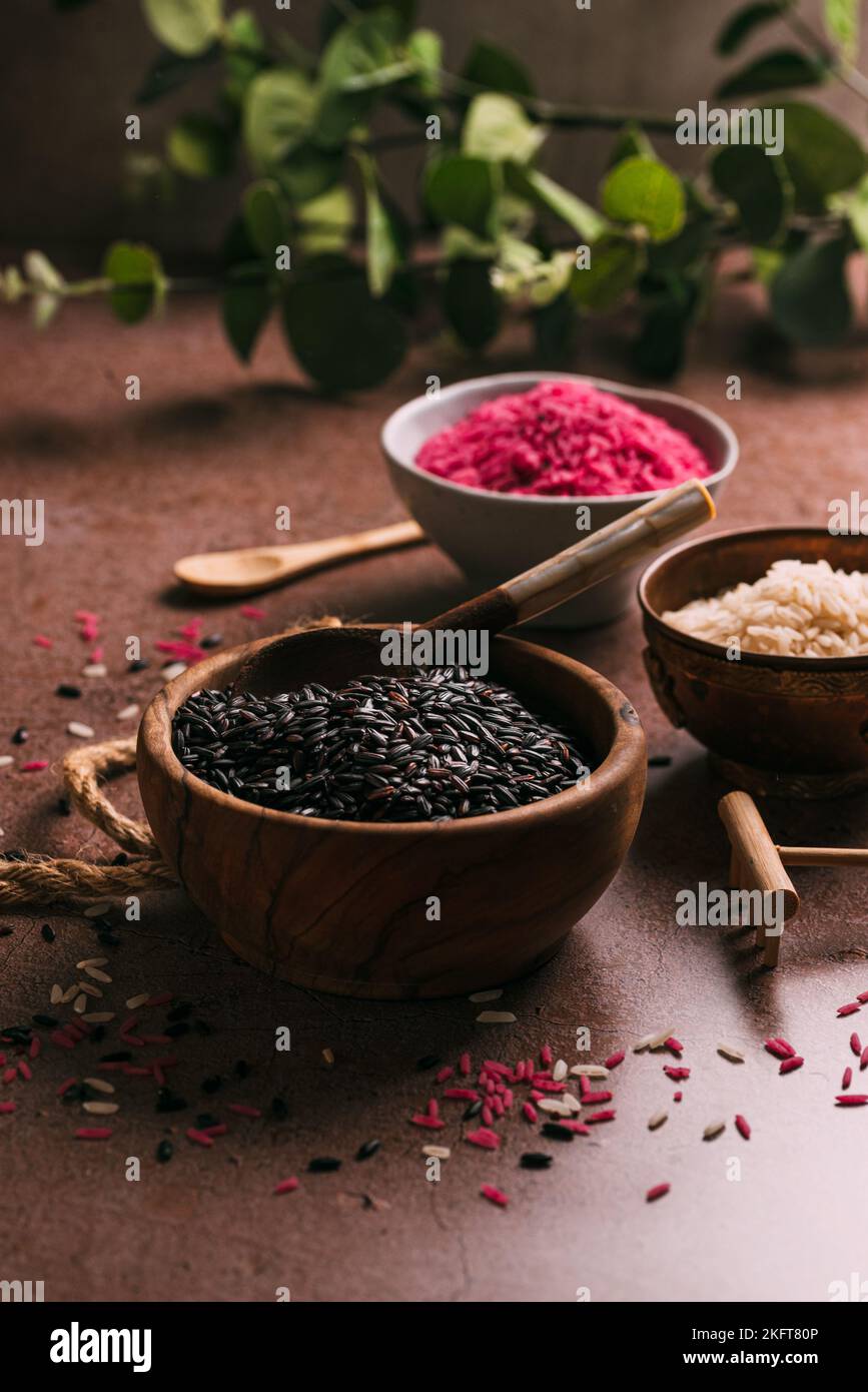 From above bowls with different types of rice placed on table near ...