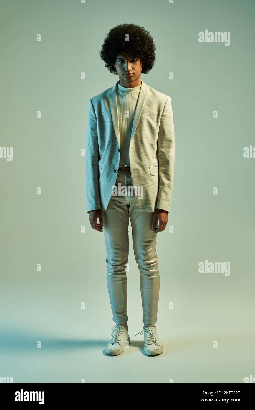 Full length young Hispanic male model in stylish suit with curly hair ...