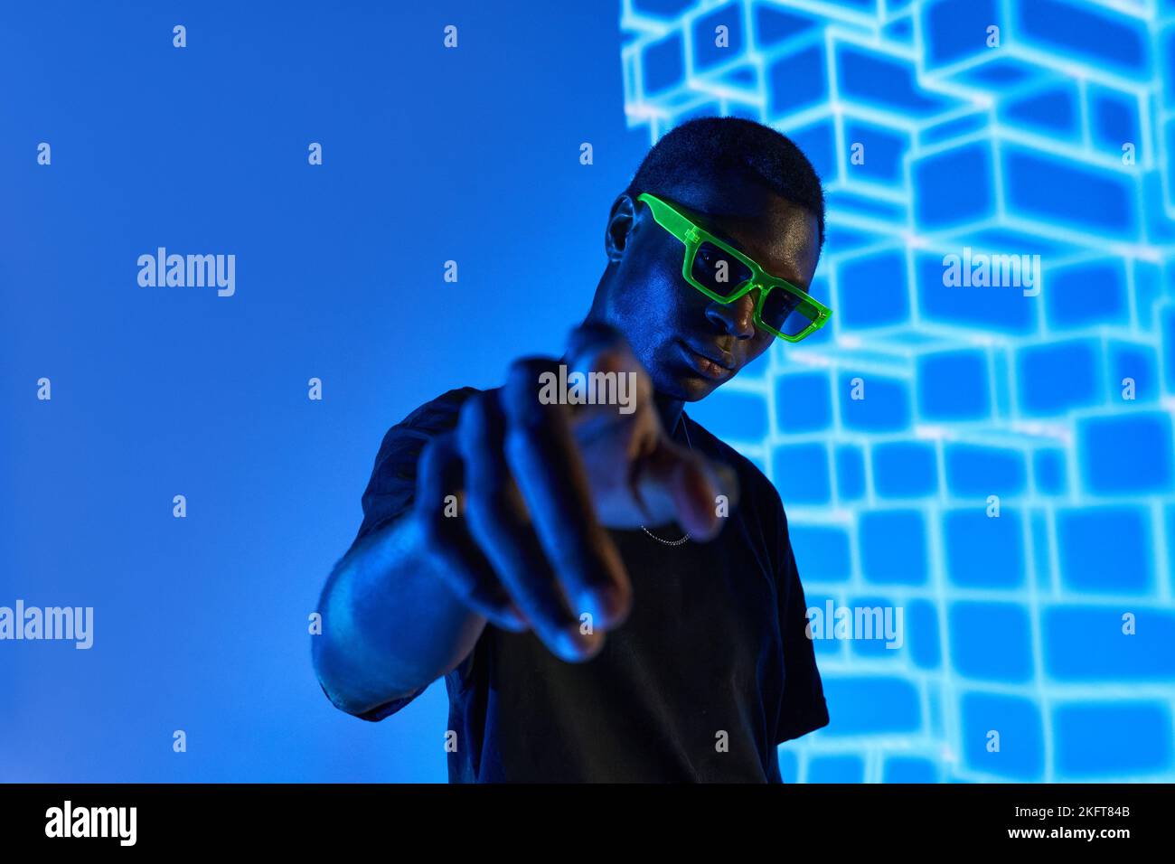 Self assured young African American male pointing and looking at camera ...