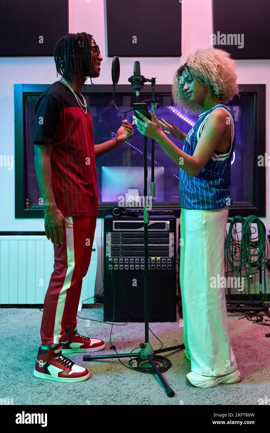 Side view full body of African American woman with Afro hairstyle using ...