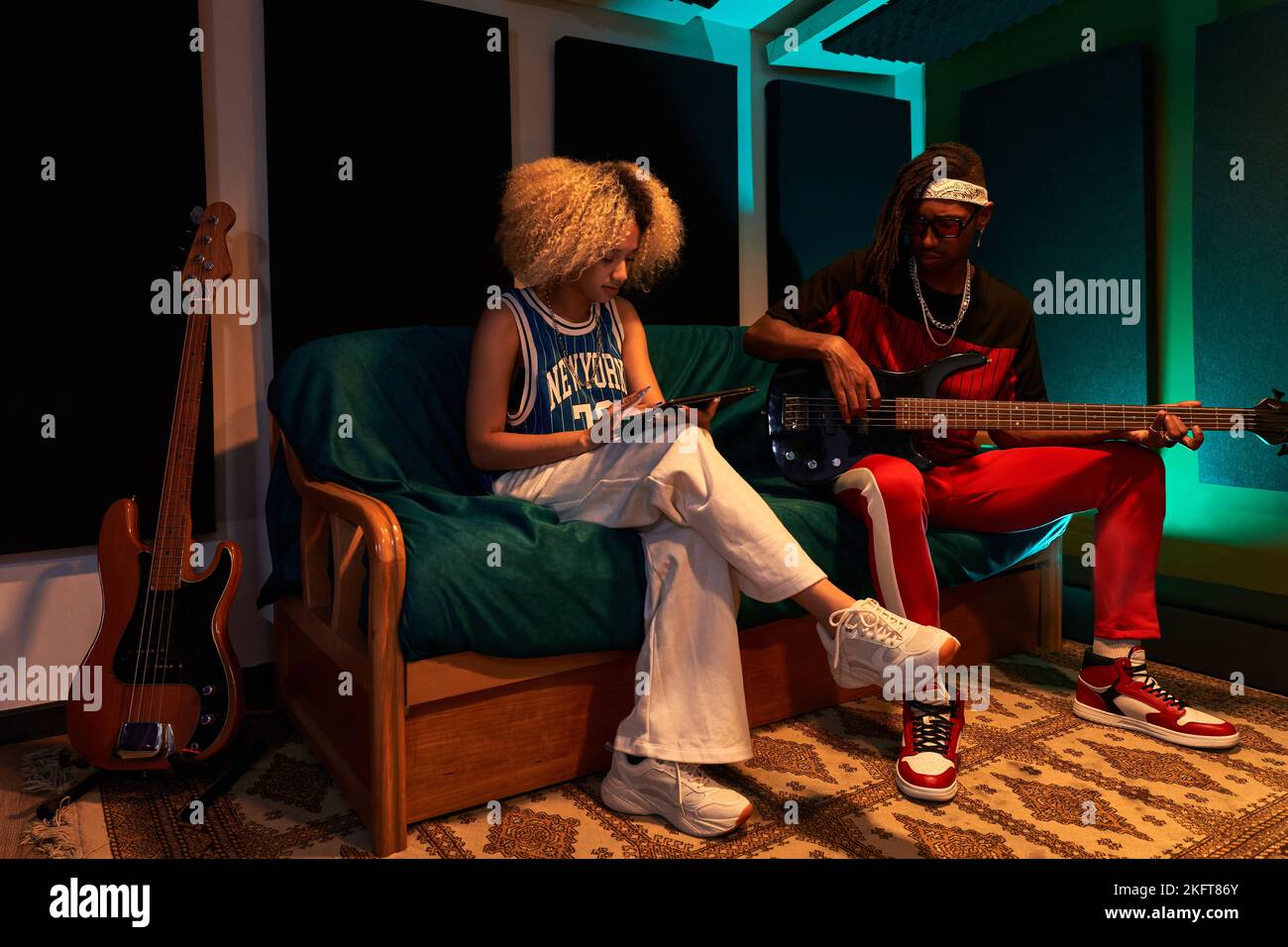 Full body of African American male musician playing electric guitar ...