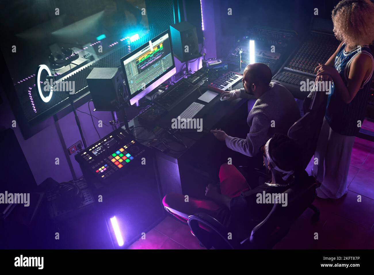 From above of diverse people gathering in modern recording studio with ...