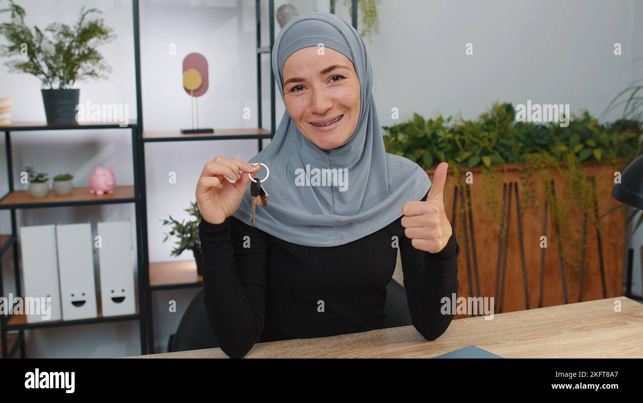 Young muslim business woman wearing hijab real estate agent lifting ...