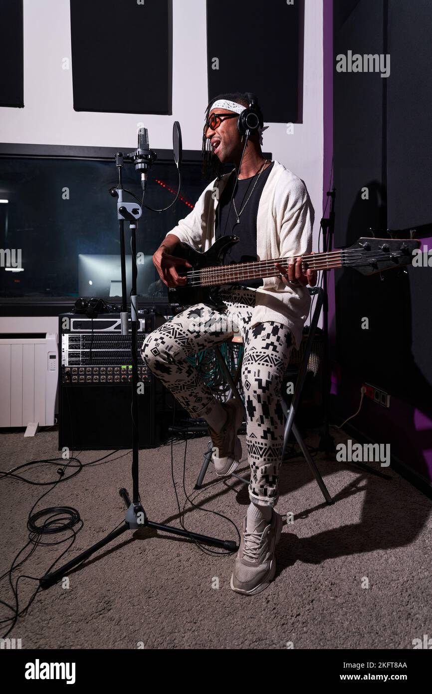 African American male musician with dreadlocks playing electric guitar ...