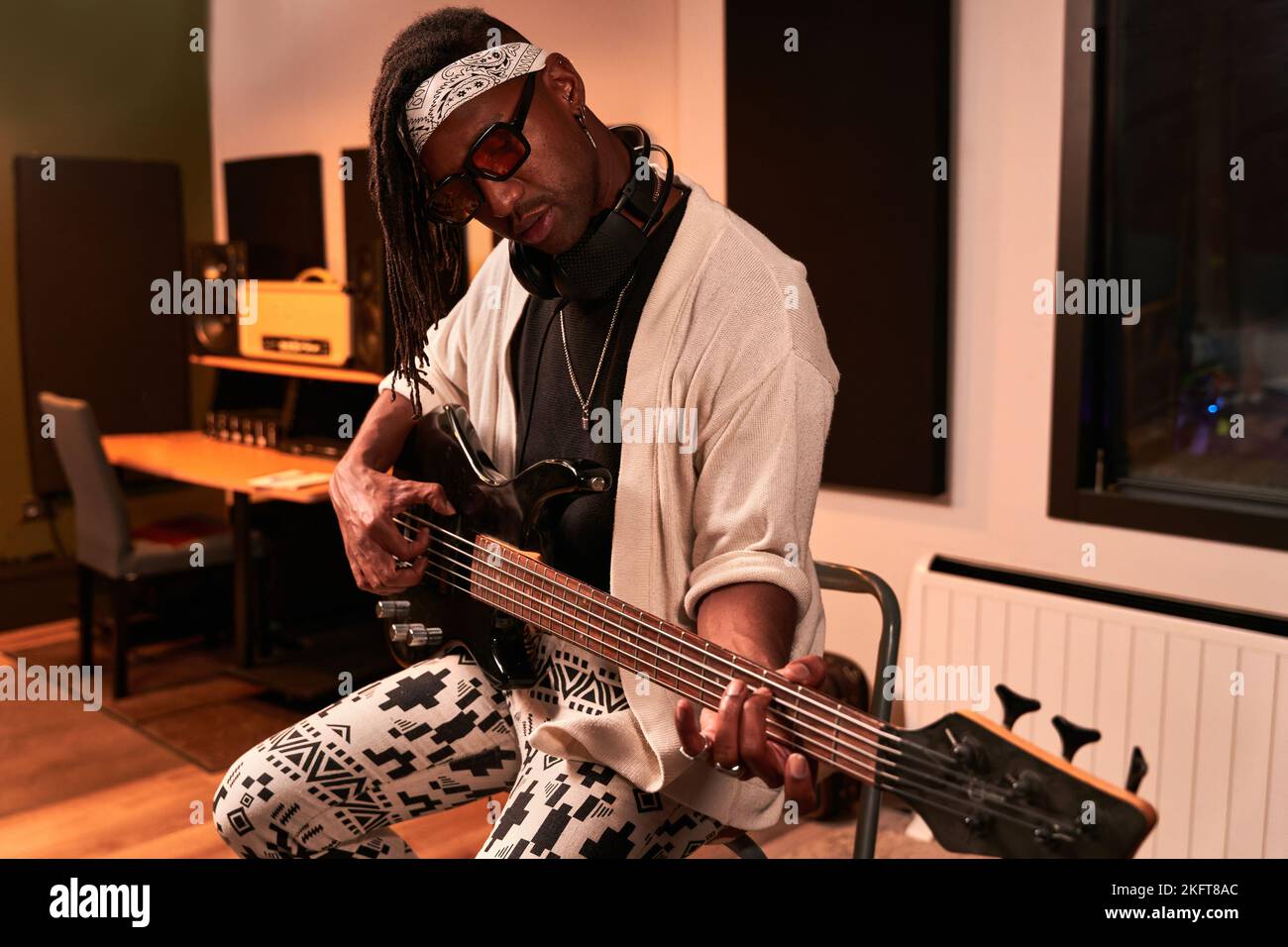 African American male musician with dreadlocks playing electric guitar ...