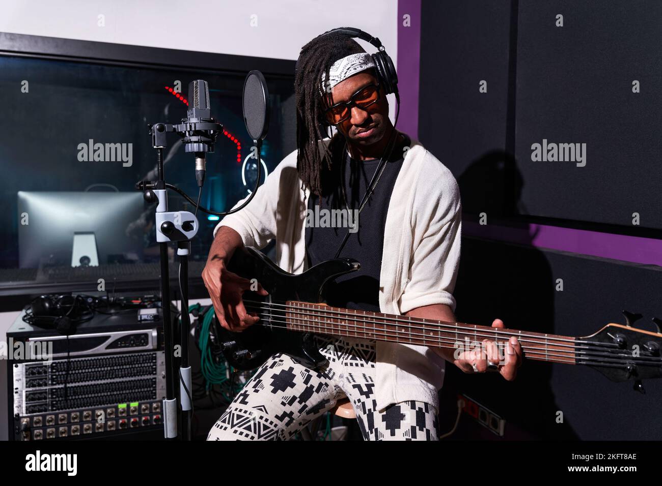 African American male musician with dreadlocks playing electric guitar ...