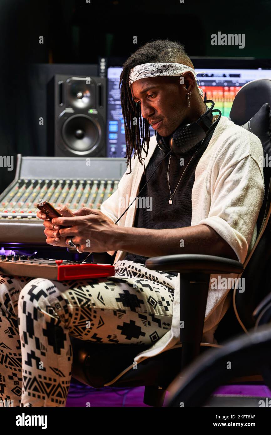 Concentrated African American male with dreadlocks bandana and ...