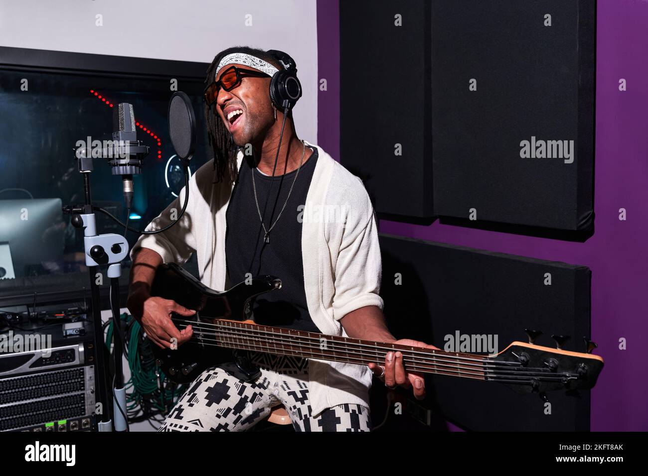 African American male musician with dreadlocks playing electric guitar ...