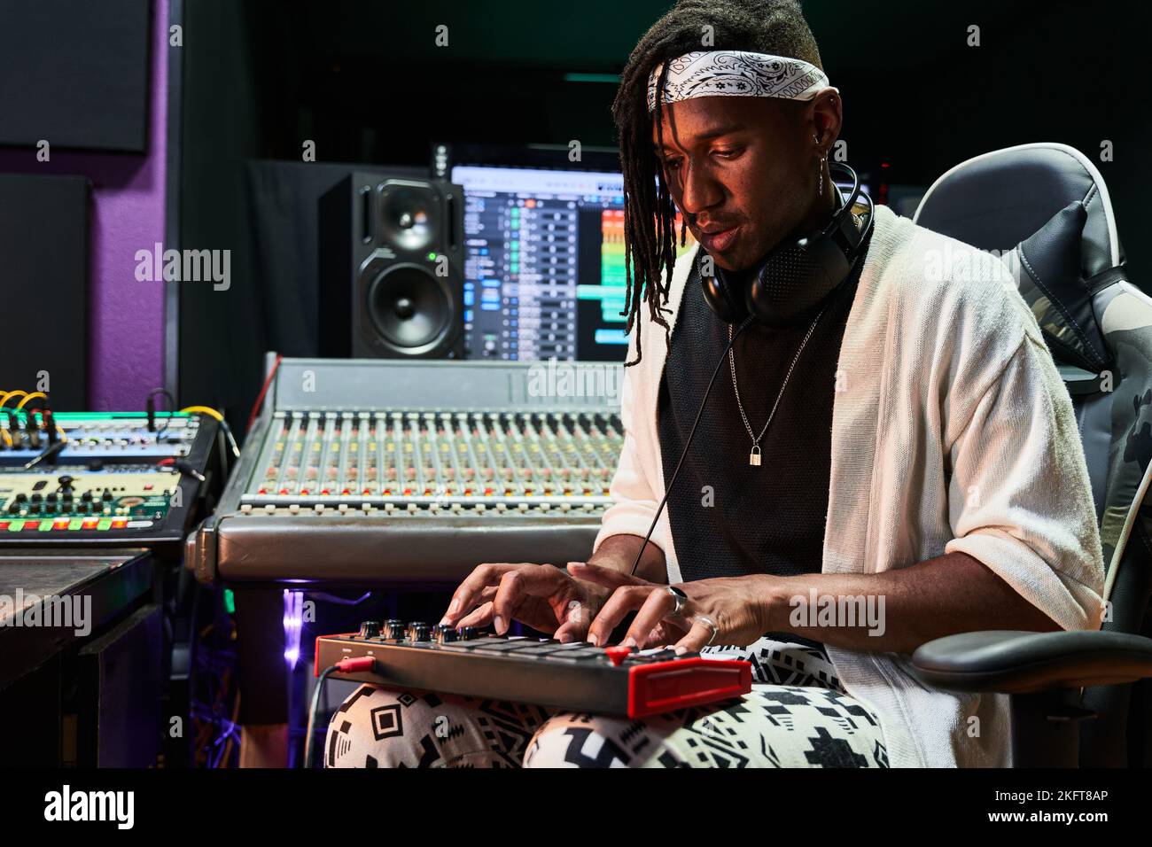 Concentrated African American male with dreadlocks bandana and ...