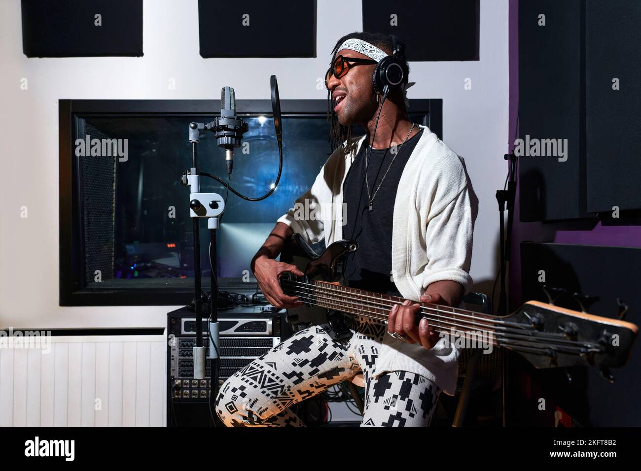 African American male musician with dreadlocks playing electric guitar ...