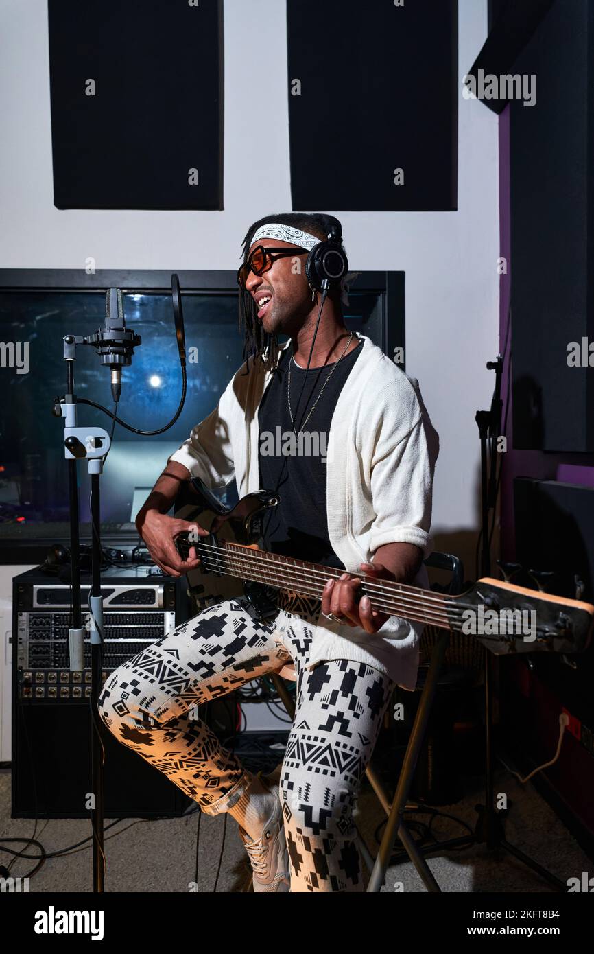 African American male musician with dreadlocks playing electric guitar ...
