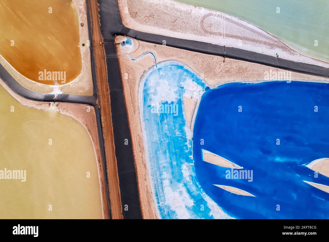 From above drone view of brine evaporation pond with blue water in ...