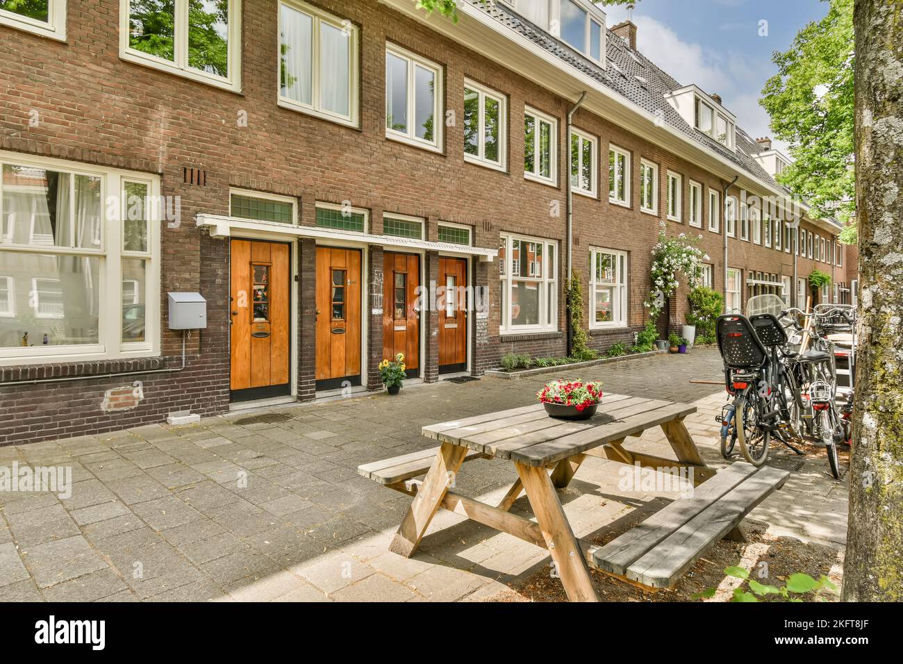View of a street with houses lined up under a blue sky with clouds ...