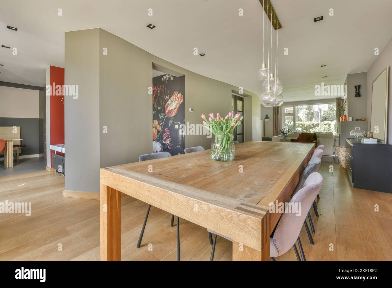 Interior of modern home with table and chairs next to a bright window ...