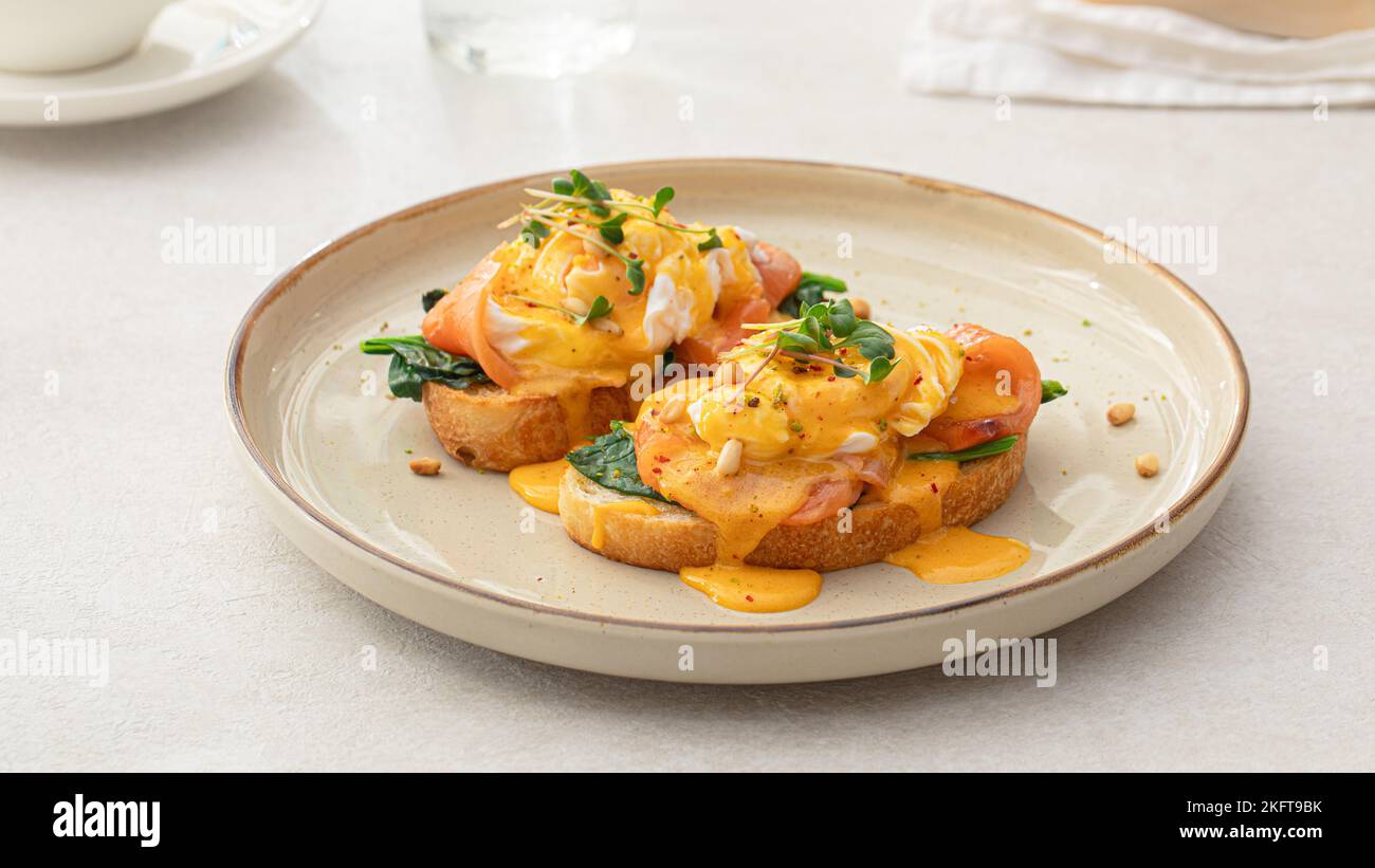 Portion of eggs benedict toast with salmon Stock Photo - Alamy
