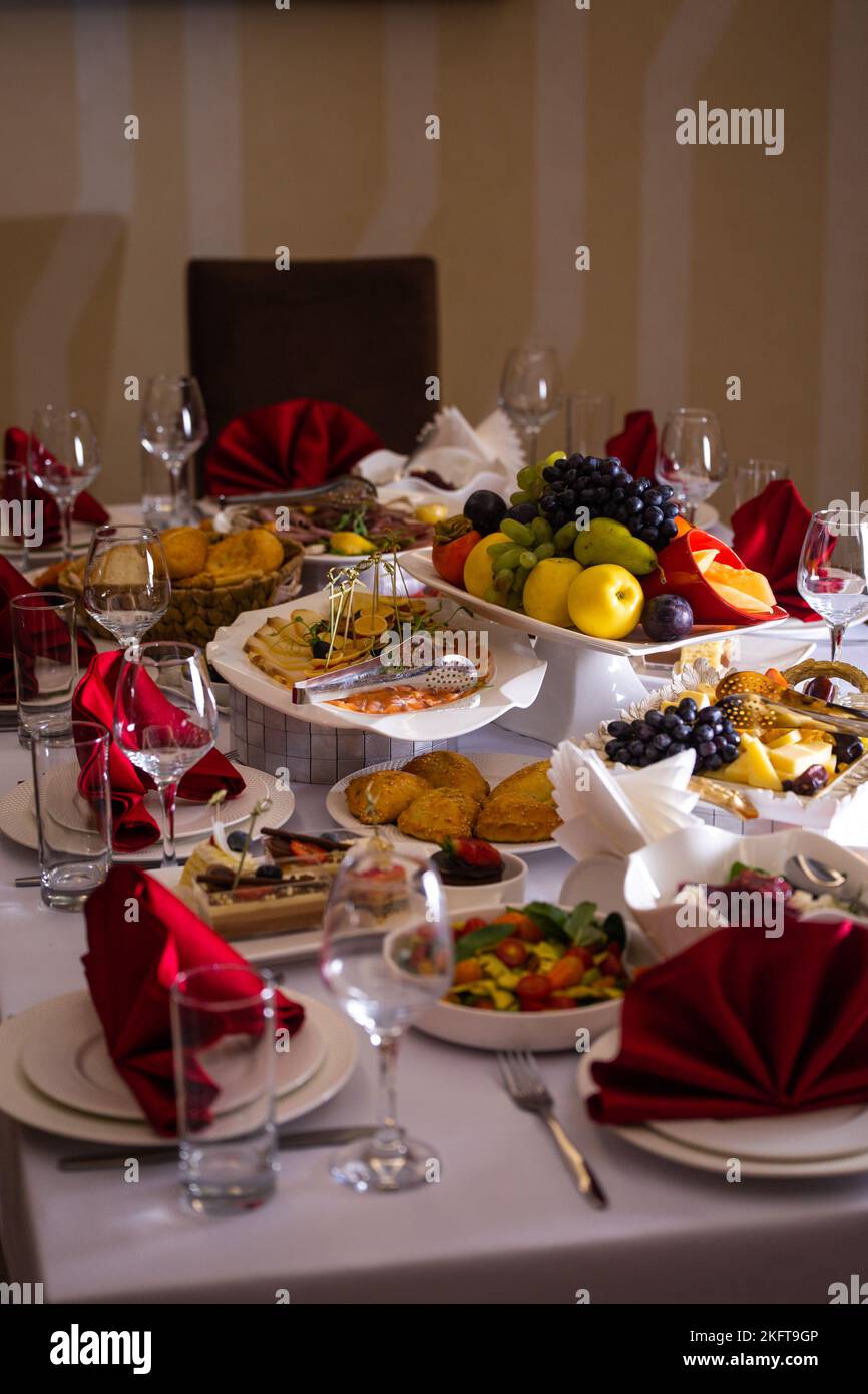 the table in the room is set in red tones with food for the holiday ...