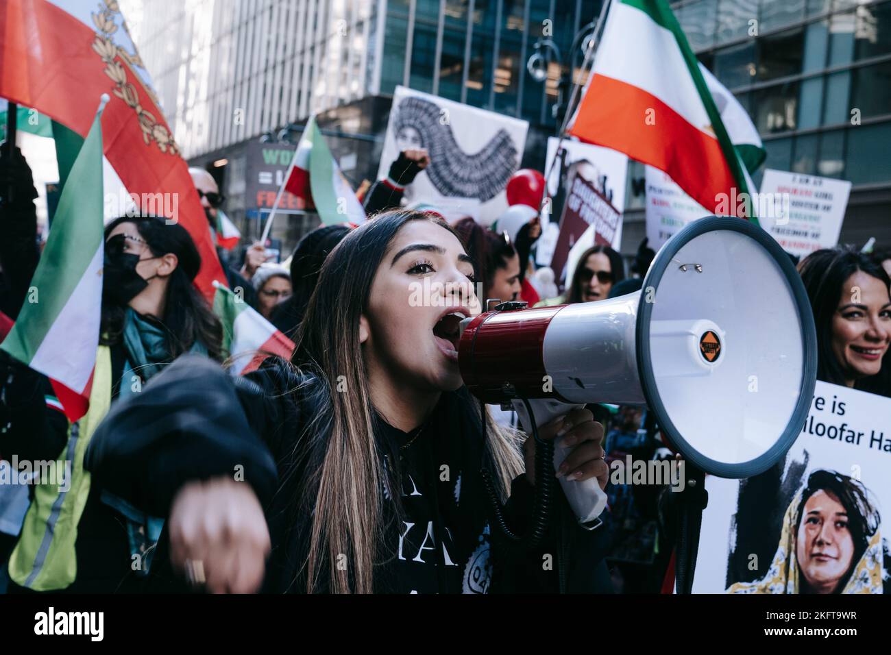 New York, United States. 19th Nov, 2022. A young woman shouts into a ...