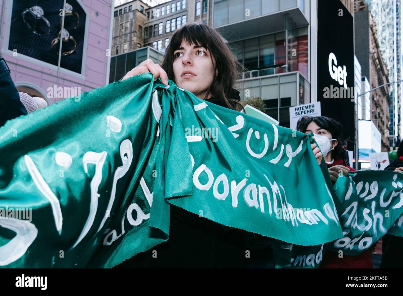 Protestors hold green cloth emblazoned with names of people reportedly ...
