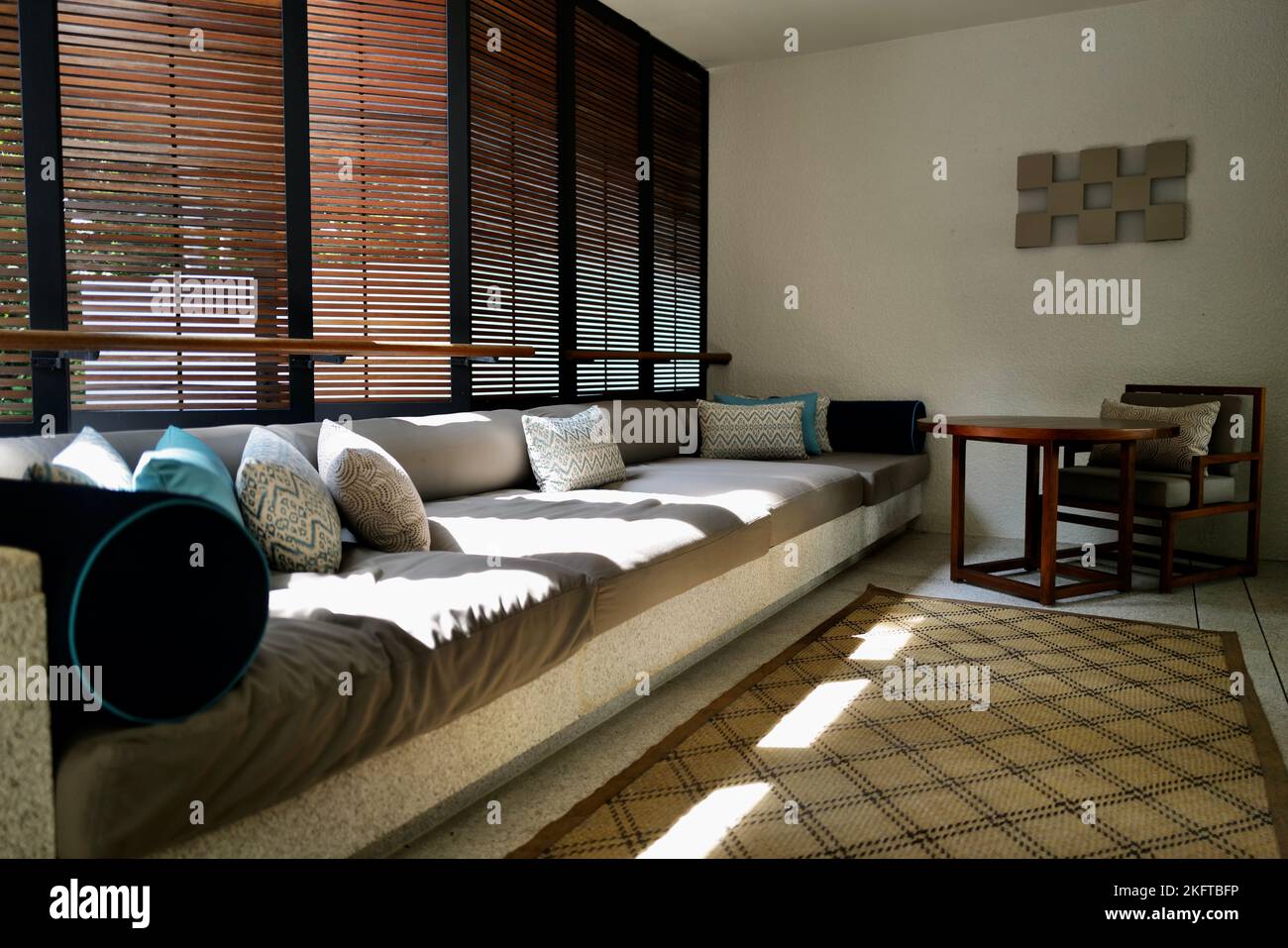 A cozy interior of a hotel room with a sofa, wooden table and window ...