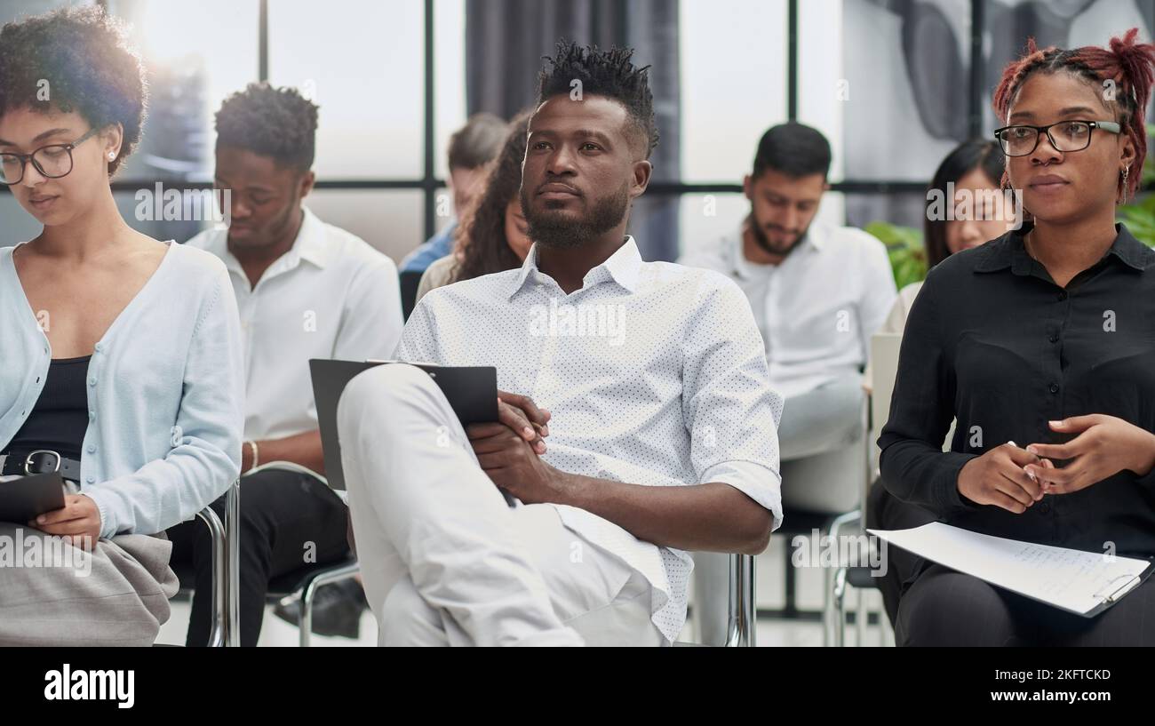 Business crowd in auditorium listeing to speech Stock Photo - Alamy