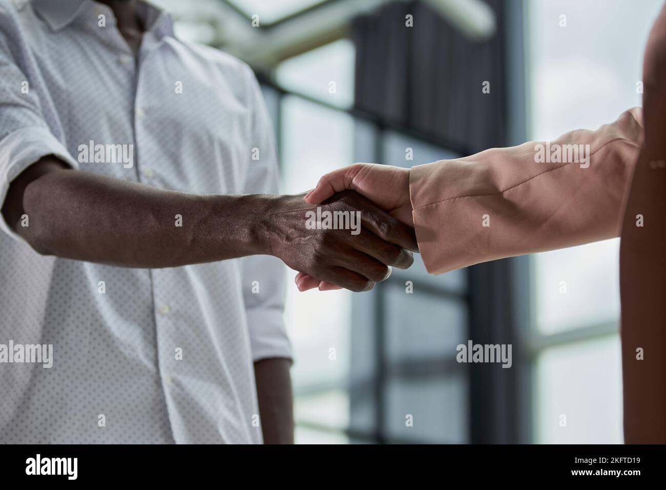 Manager greeting new employee and smiling in office Stock Photo - Alamy