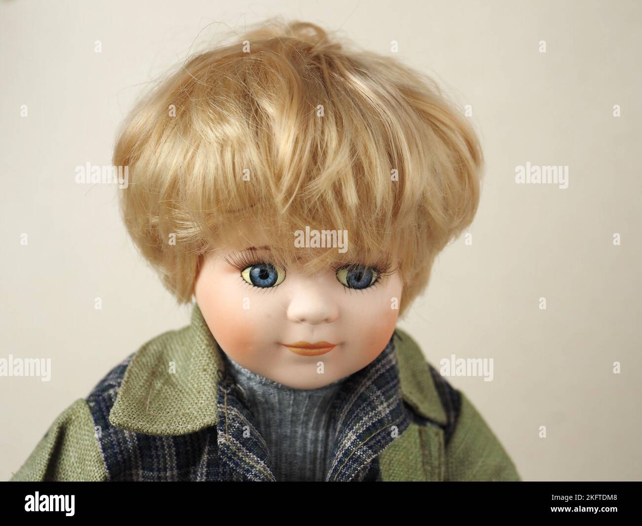 Vintage porcelain doll girl with blue eyes, blond short hair in gray ...