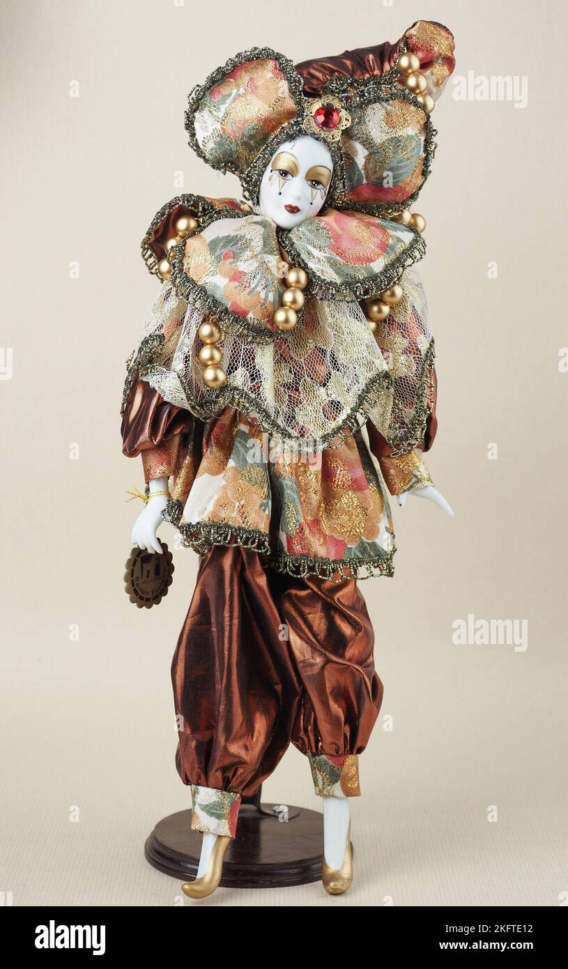 Porcelain doll depicting the hero of the Commedia Del Arte Harlequin ...
