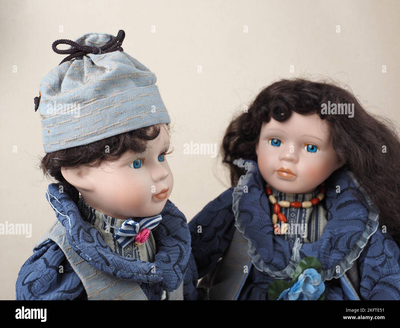 Vintage porcelain dolls blue-eyed boy and girl with dark hair in gray ...
