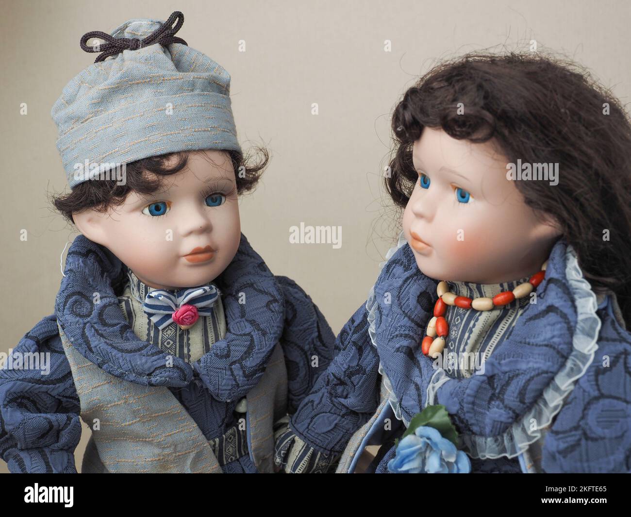 Vintage porcelain dolls blue-eyed boy and girl with dark hair in gray ...