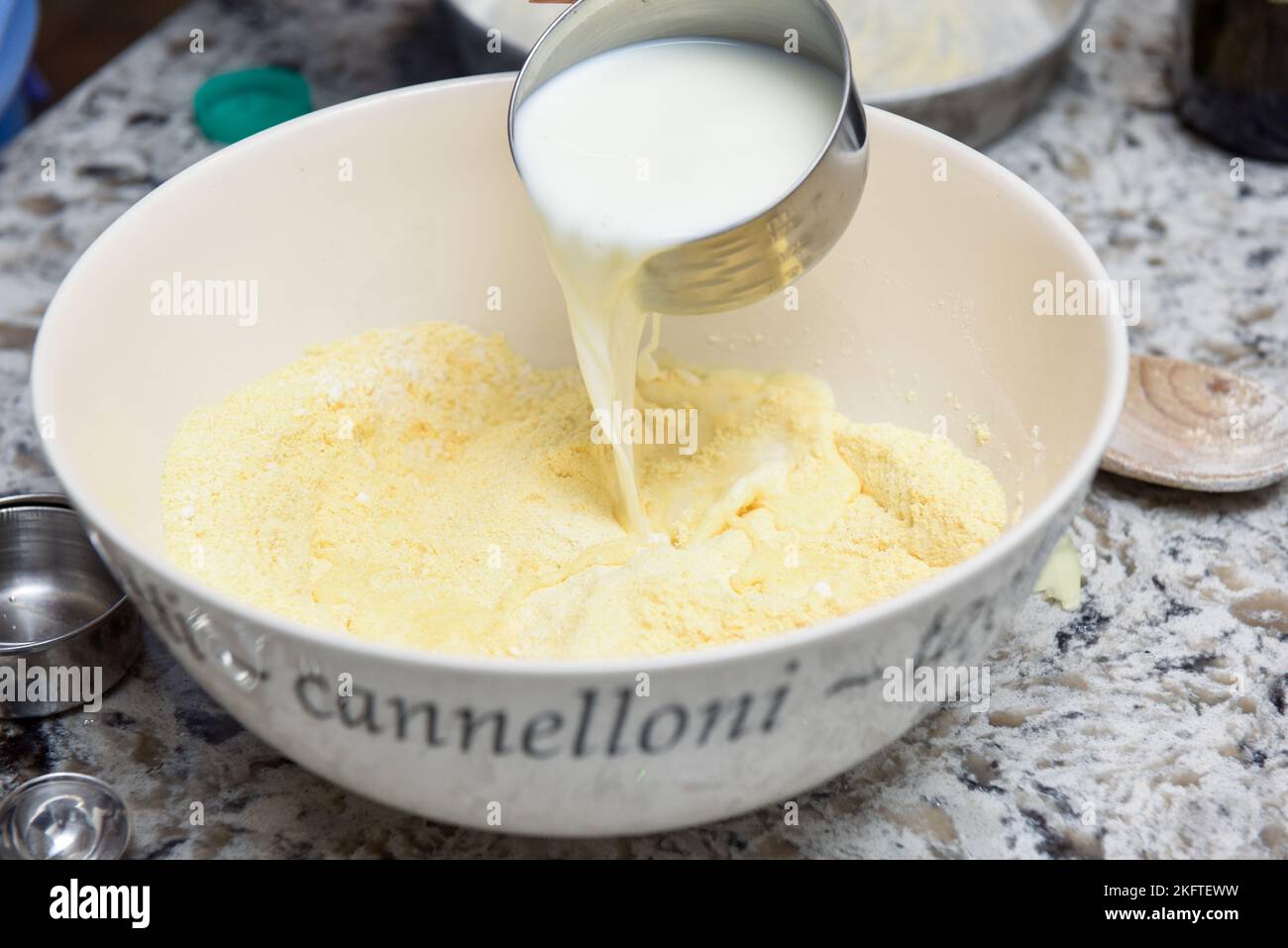 Baking bread at home by pouring milk into flour mixture Stock Photo - Alamy