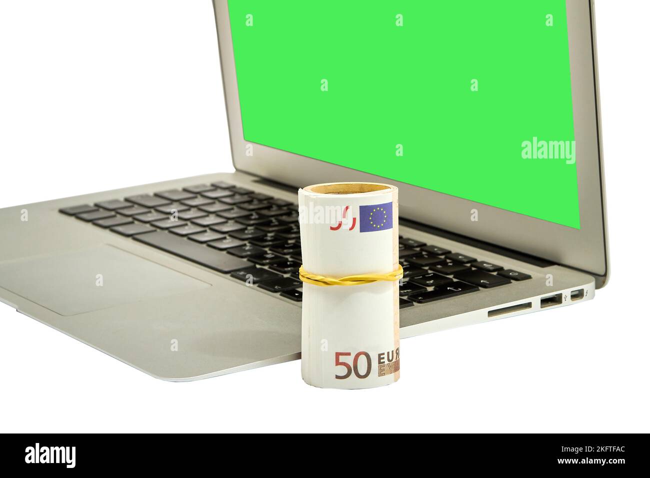 Rolled up in a tube 50 euro bills stand near the computer, chromakey ...