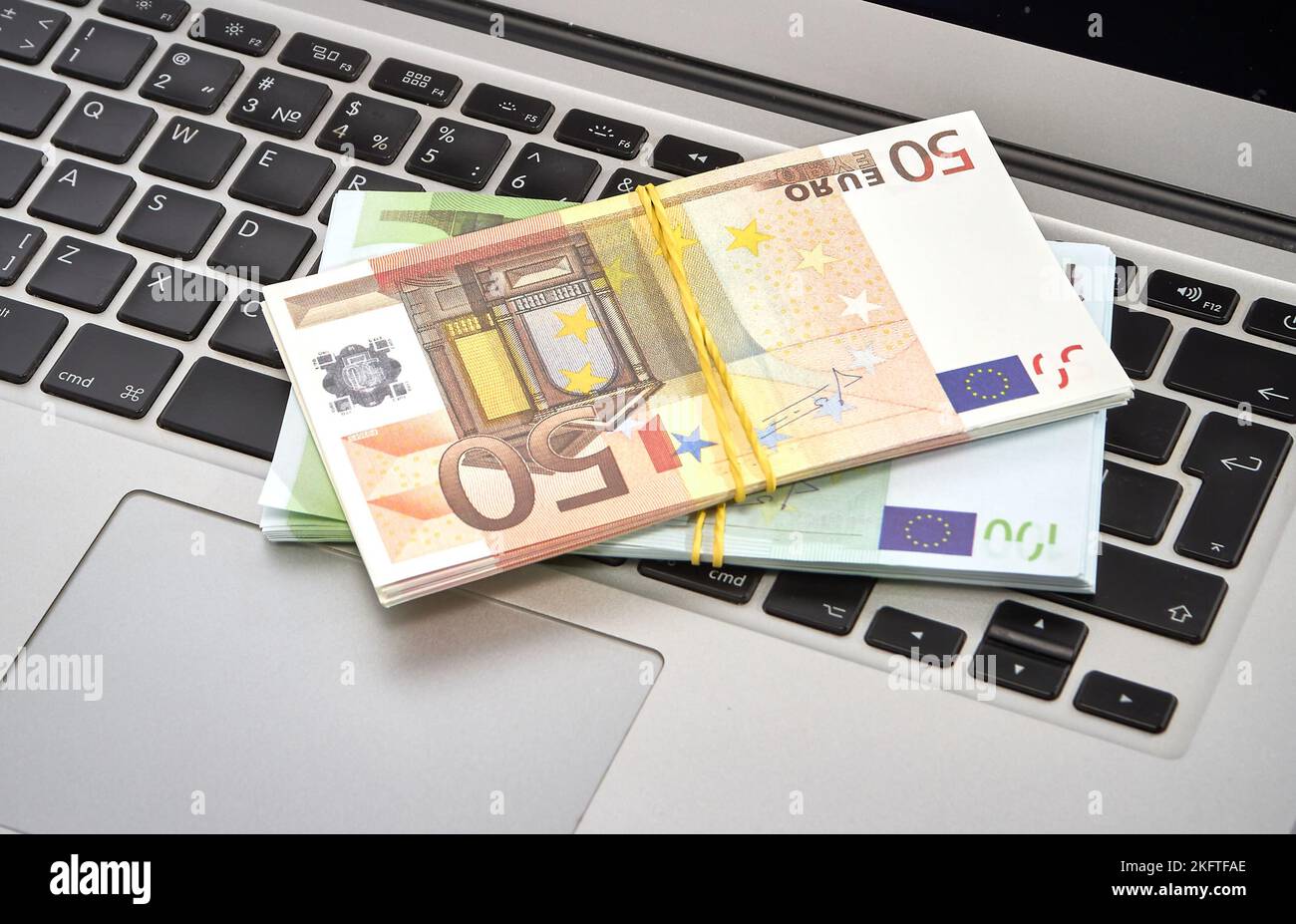 Packs of 100 and 50 euro bills lying on the computer keyboard Stock ...