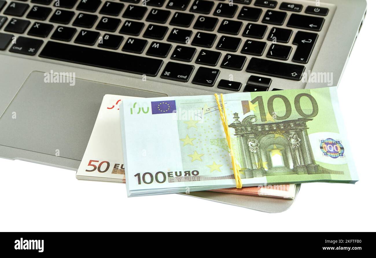 Packs of 100 and 50 euro bills lying on the computer keyboard Stock ...