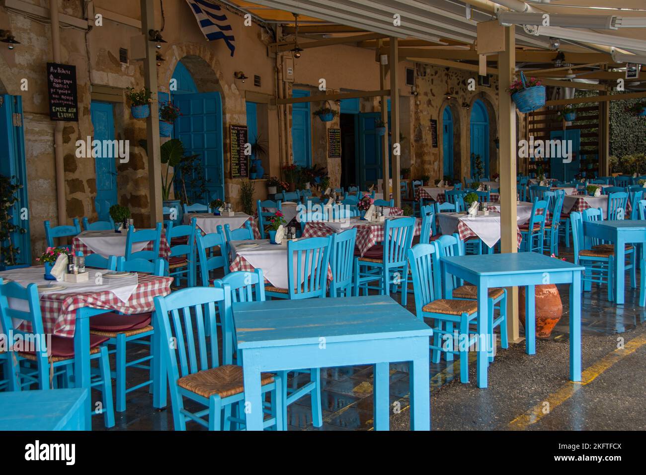 Chania, Greece 19 May 2022, idyllic restaurant with light blue chairs ...