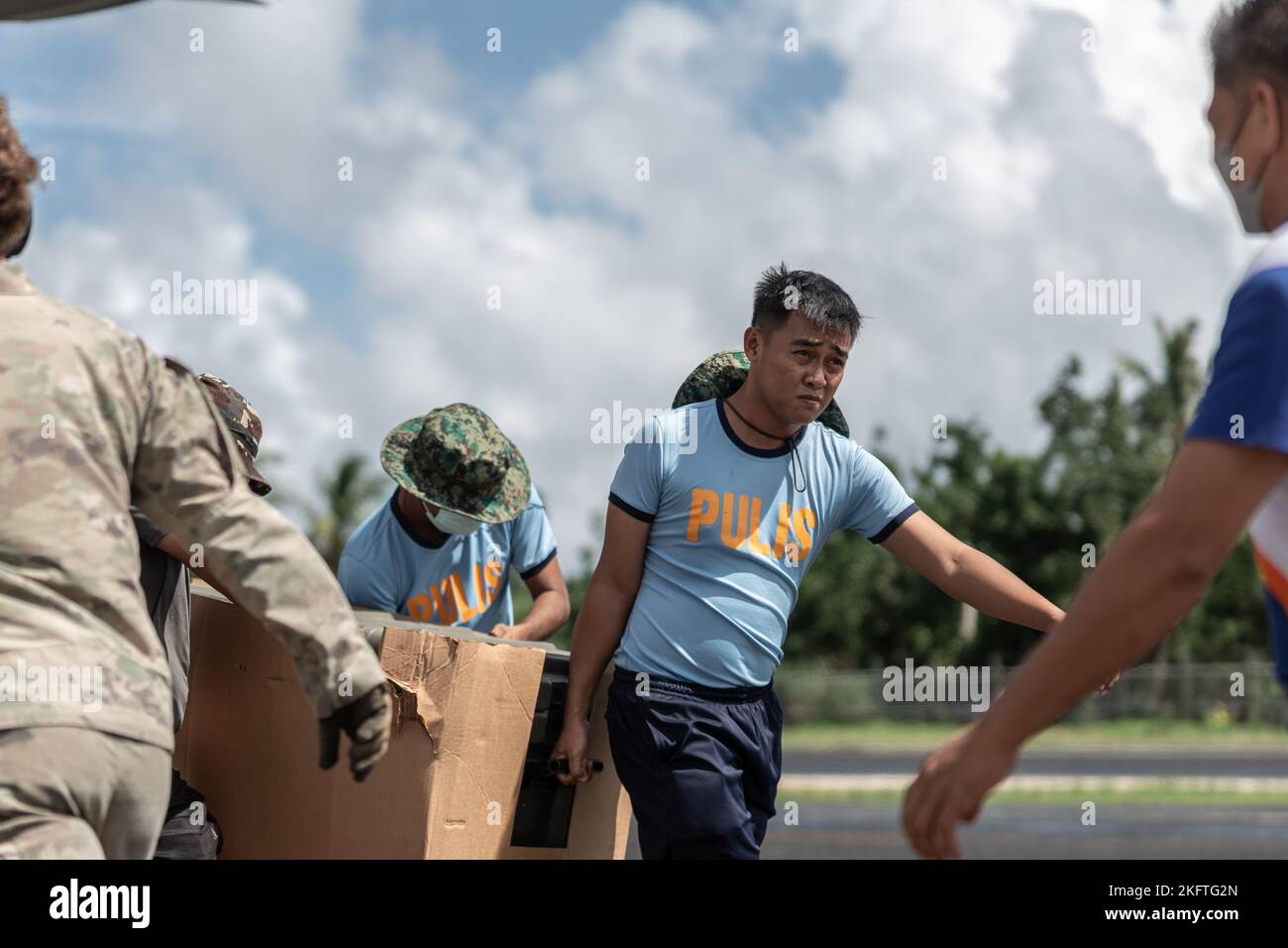 U.S. service members and host nation representatives offload medical ...