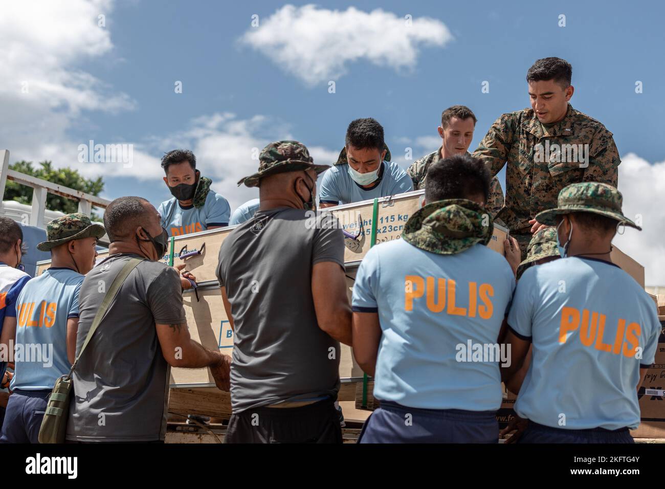 U.S. service members and host nation representatives offload medical ...