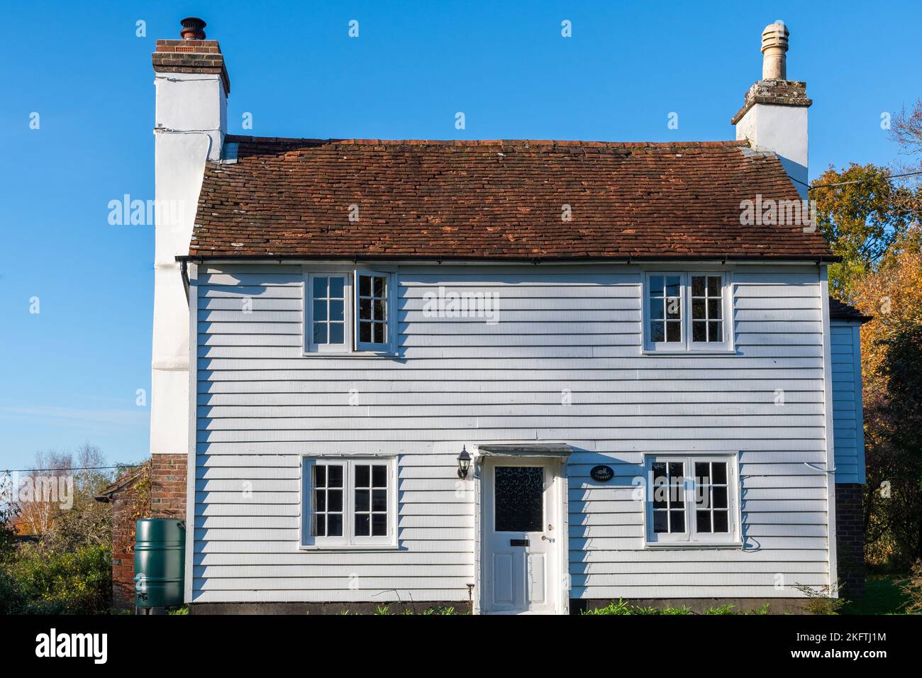 A white clapper-board cottage in Cowbeech, East Sussex on a fine autumn ...