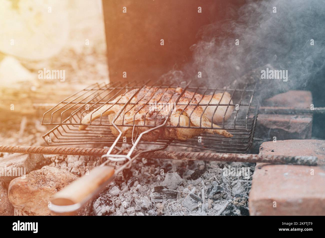 chicken meat food fried on grill on smoldering coals or ember from a ...