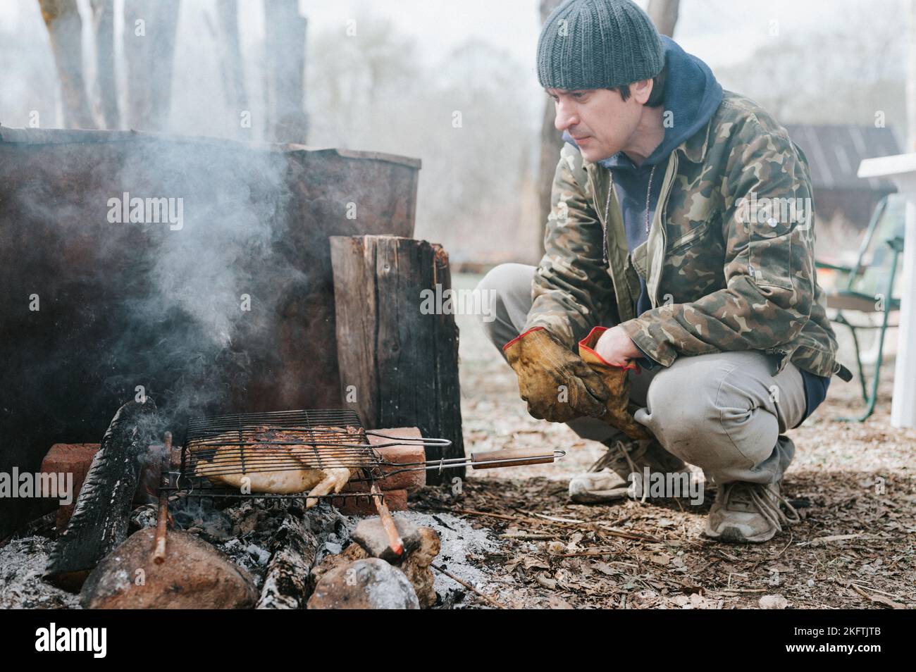 Man cooks meat on camping hi-res stock photography and images - Alamy