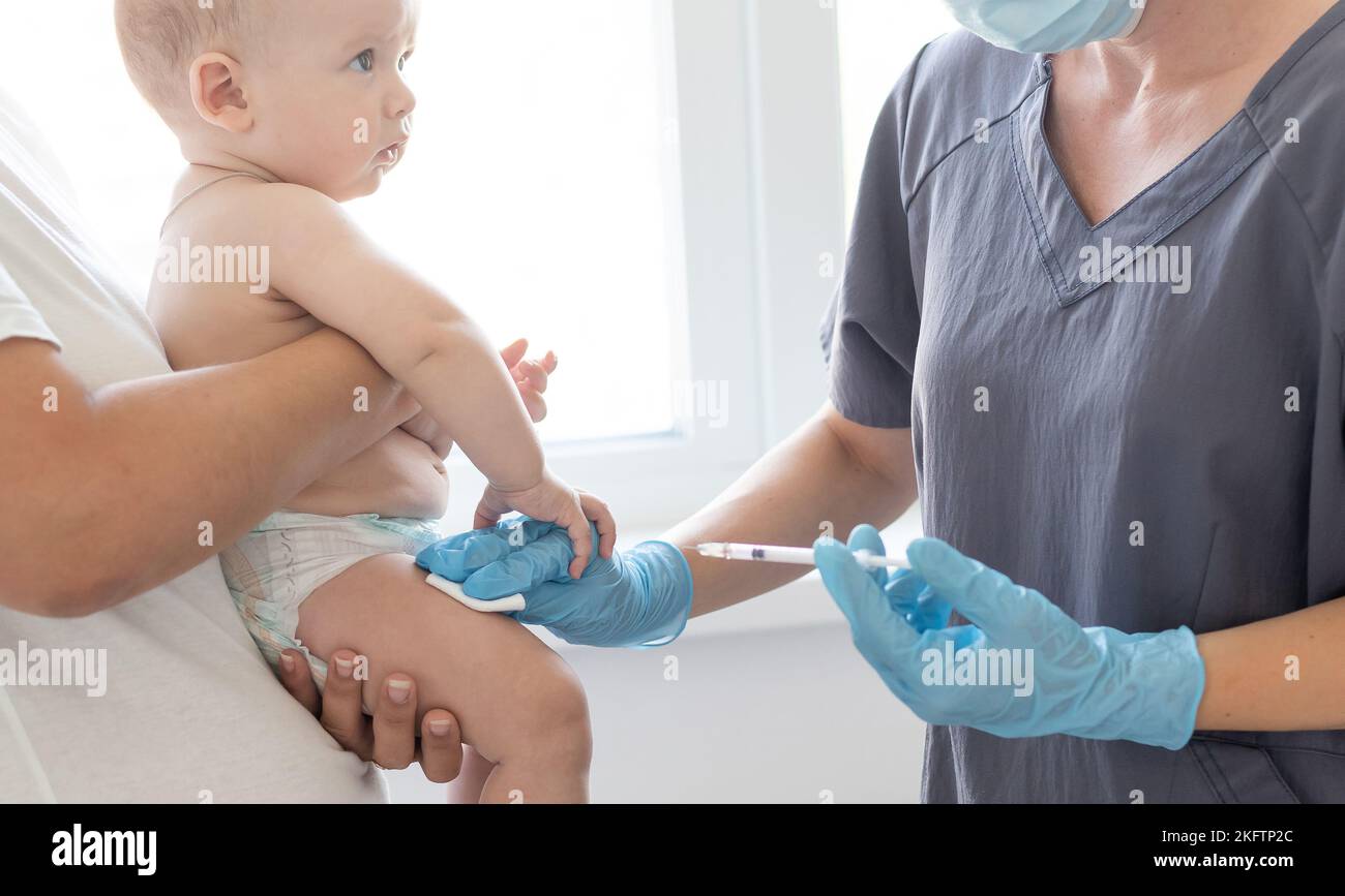 The doctor makes a baby vaccination on a white background Stock Photo ...