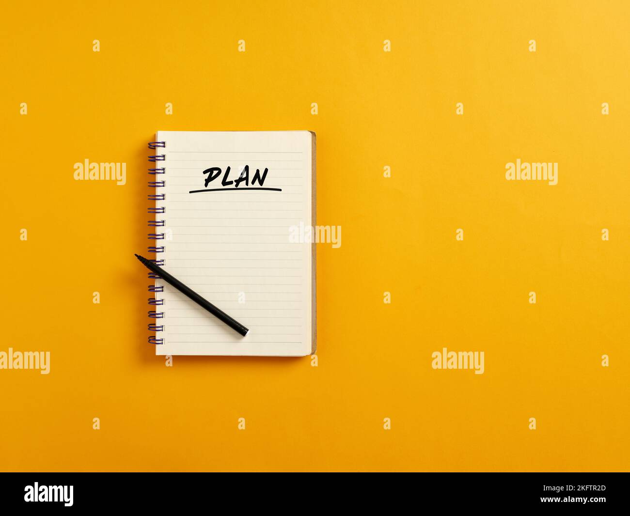 Notepad and black pen with the word plan. Business or financial ...