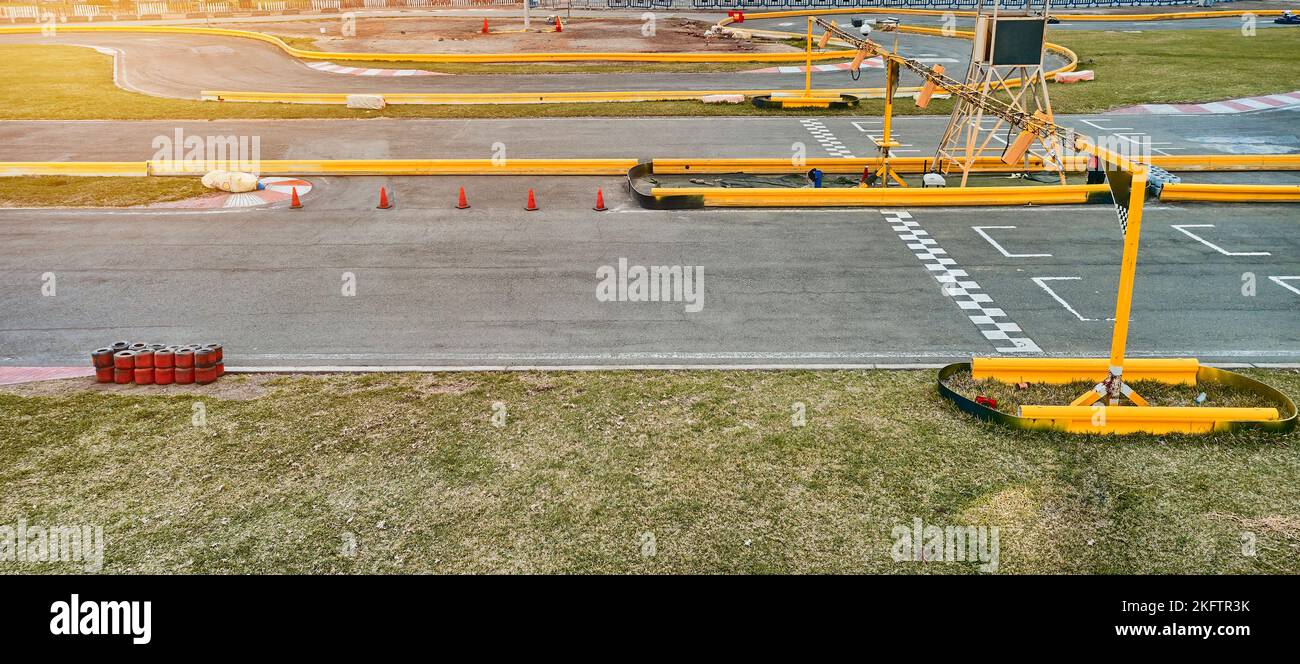 Aerial top view of the go-kart track from the drone. Kart racers drive ...