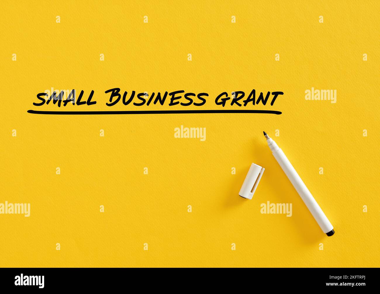 Small business grant on yellow background with felt tip pen Stock Photo ...