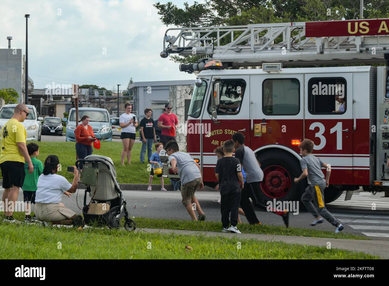 Children watching the Fire Prevention Week parade run to keep up with ...