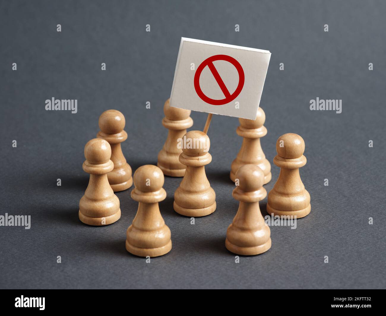 Chess pawn protester holding a NO sign banner surrounded by the crowd ...