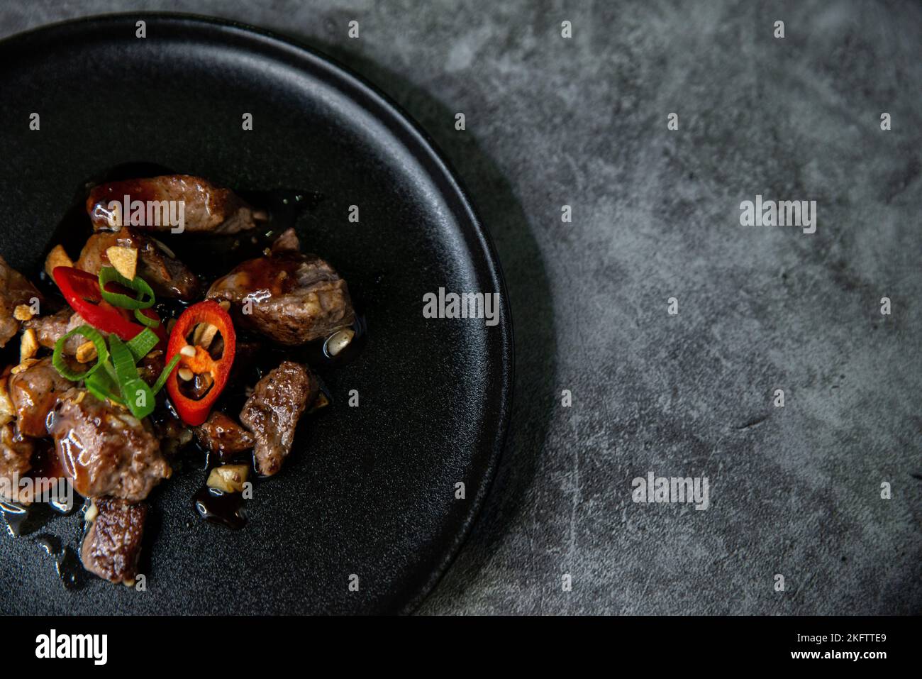 Closeup shot of Korean Galbi Jjim, braised short ribs with spring onion ...