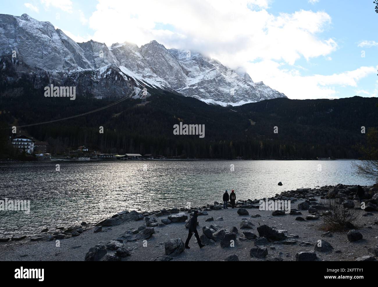 Grainau, Germany. 20th Nov, 2022. Strollers walk along the shore of the ...